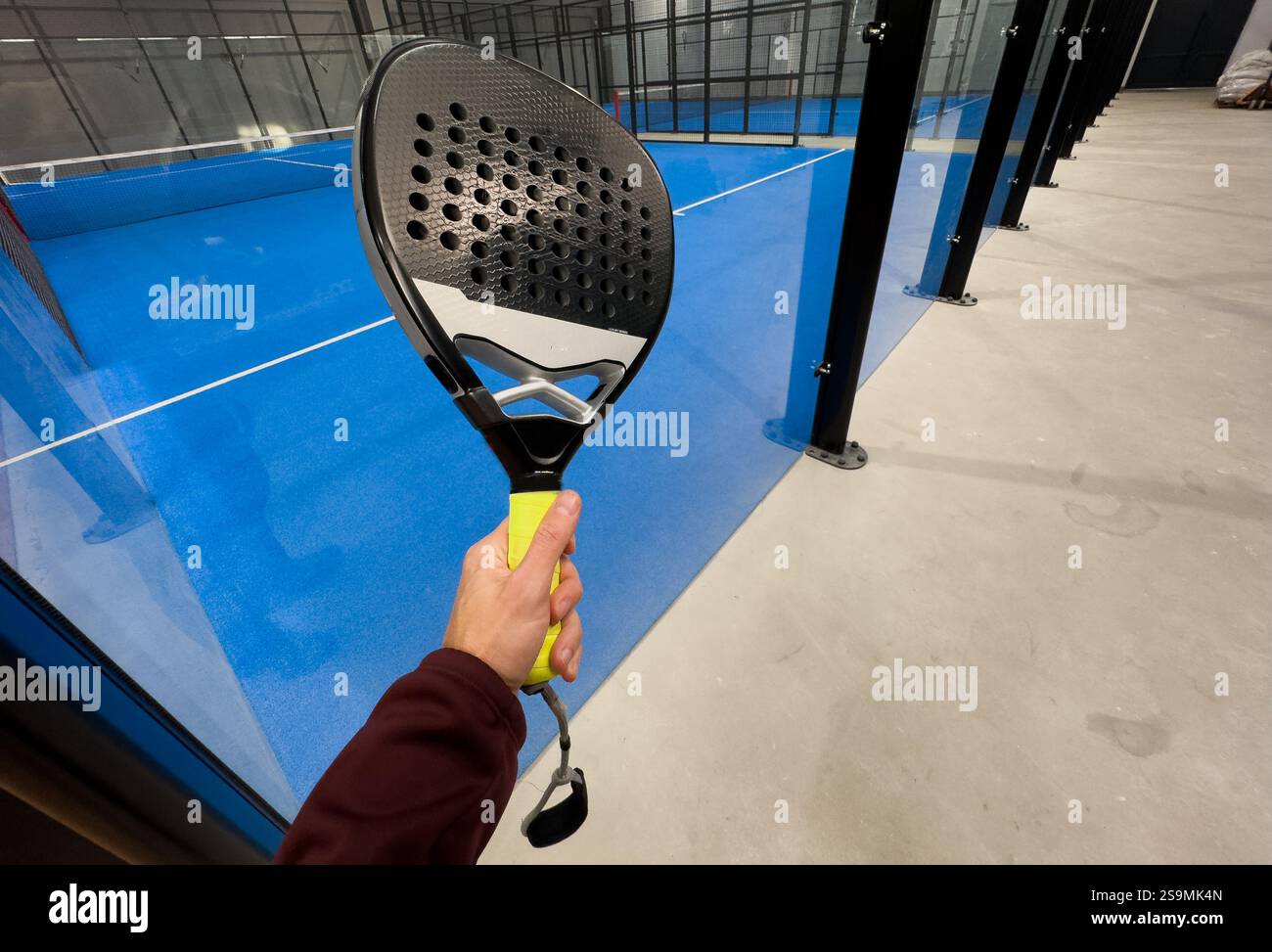 padel racket on a padel court with a ball Stock Photo - Alamy