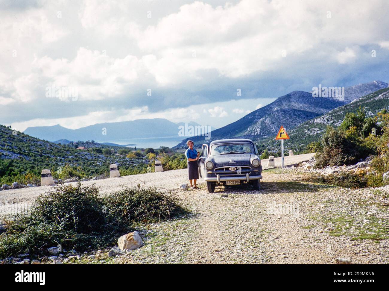 Woman standing by Triumph Standard Vanguard car with CD suffix ...