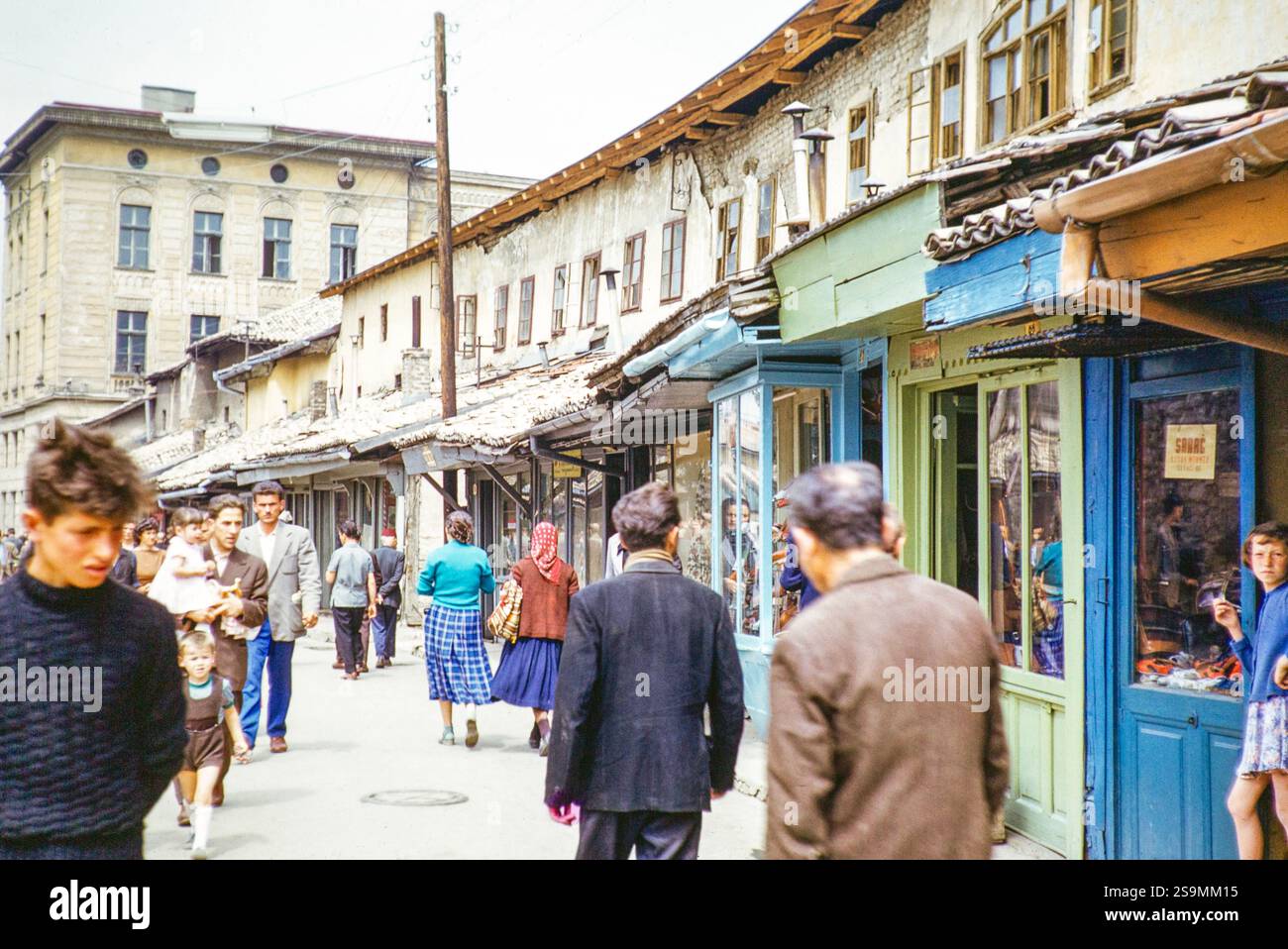 People walking along street of small shops, Sarajevo, Bosnia and ...