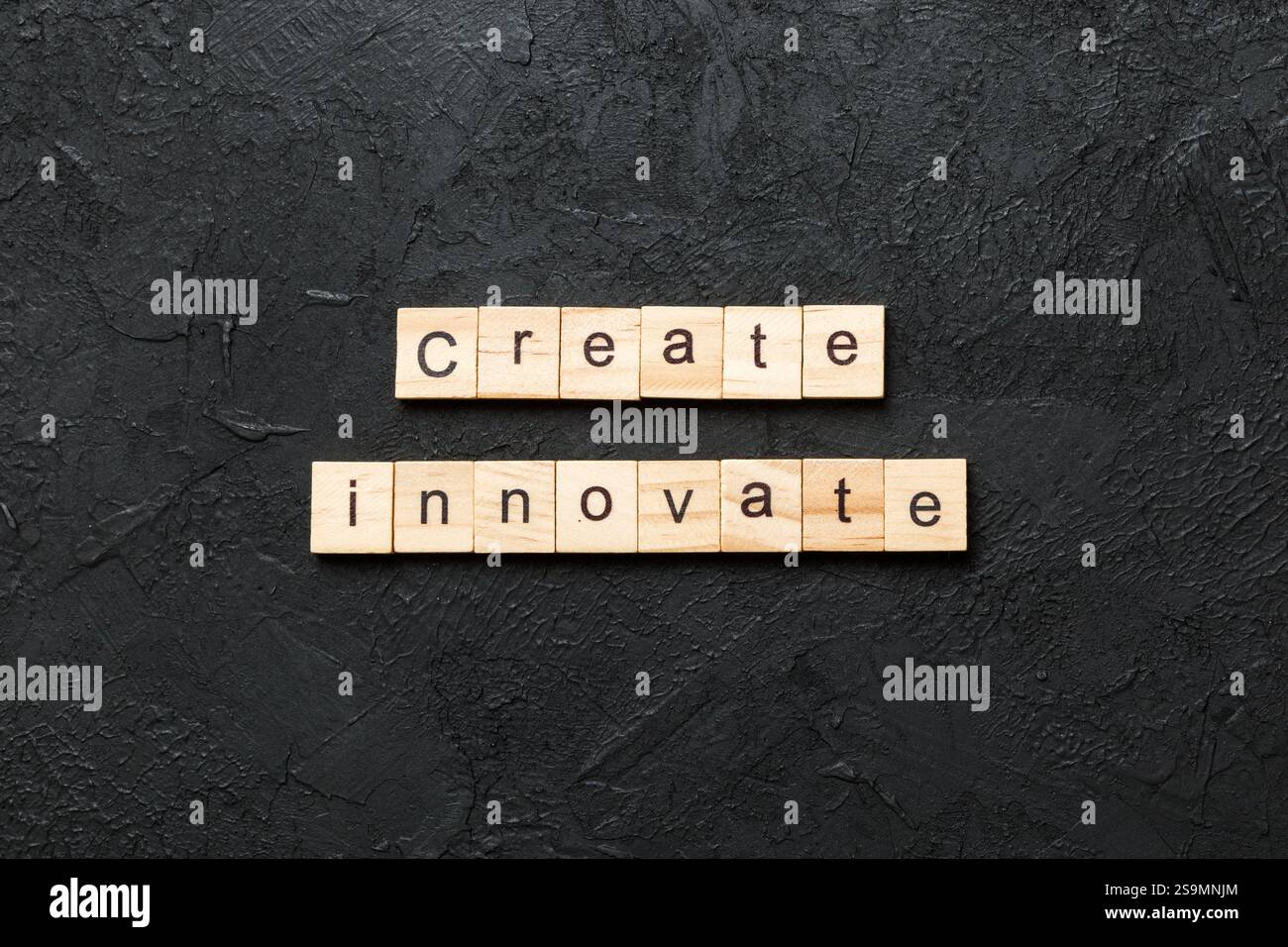 Create innovate word written on wood block. Create innovate text on ...