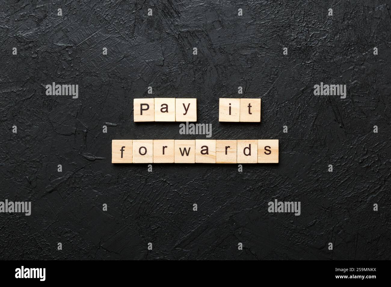 Pay It Forward word written on wood block. Pay It Forward text on ...