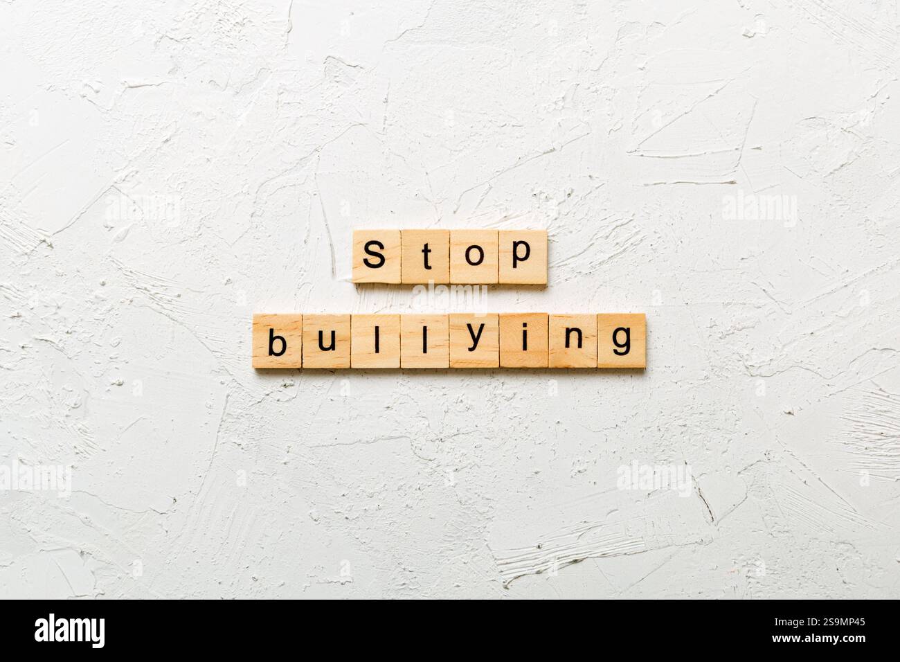 Stop Bullying word written on wood block. Stop Bullying text on cement ...