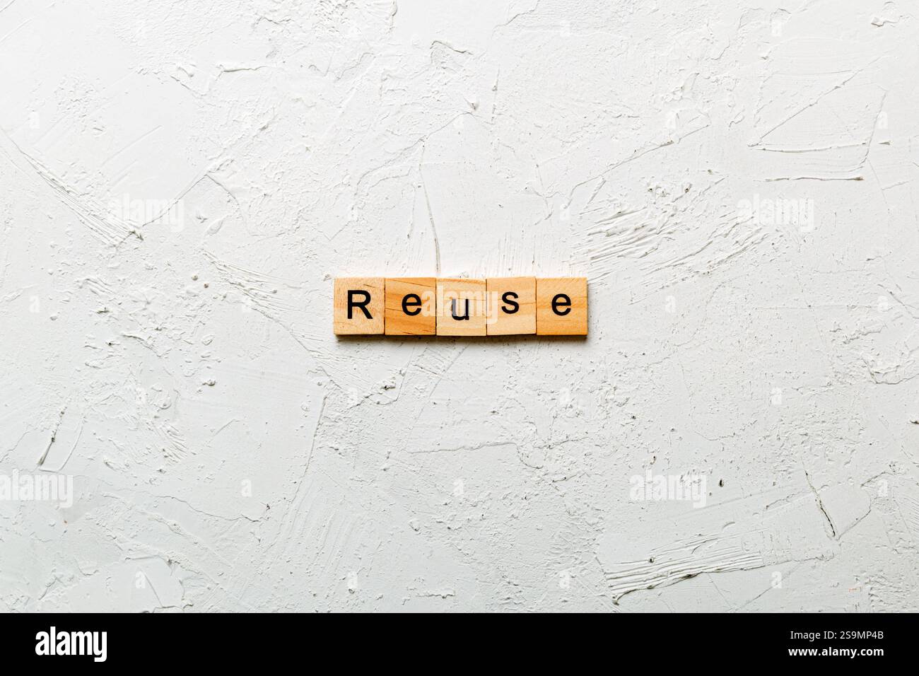 reuse word written on wood block. reuse text on cement table for your ...