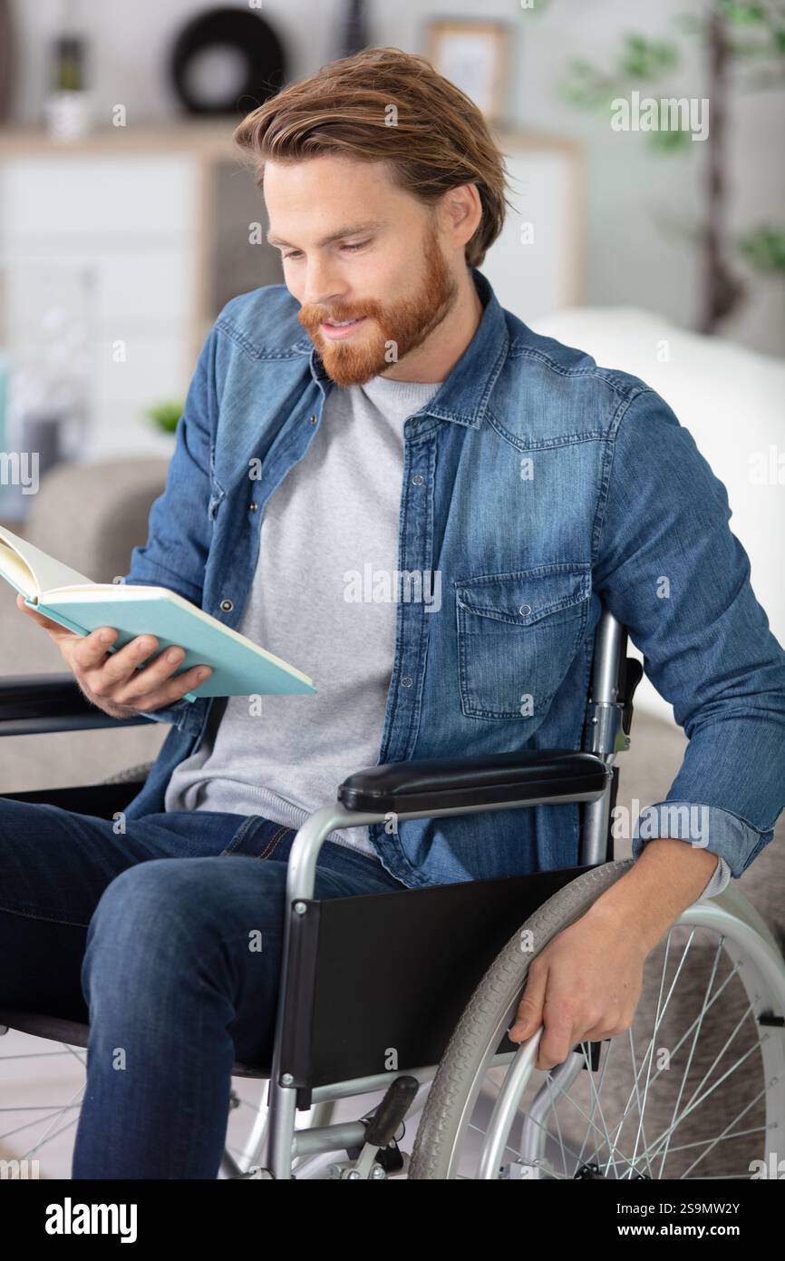 physically handicapped man in wheelchair with a book Stock Photo - Alamy