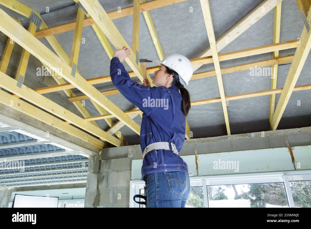 female carpenter working on a wood structure Stock Photo - Alamy