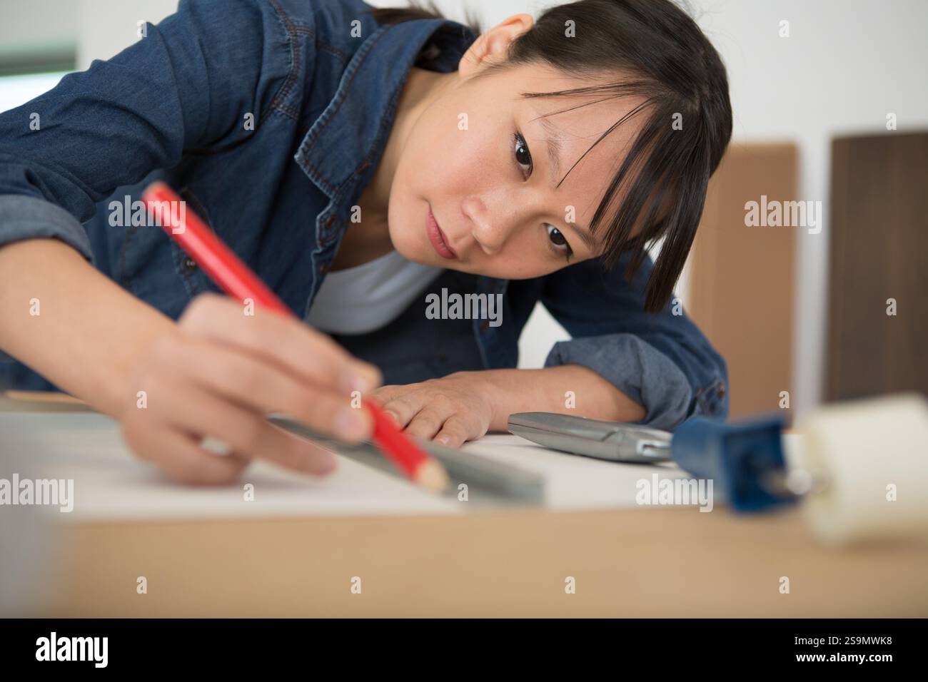 female engineer using pencil drawing Stock Photo - Alamy