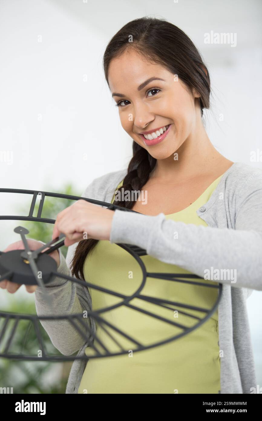 woman changing the time on a clock Stock Photo - Alamy