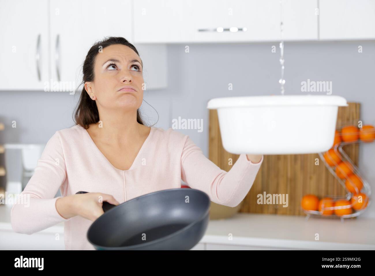 homeowner watching ceiling leaks sitting on a couch at home Stock Photo ...