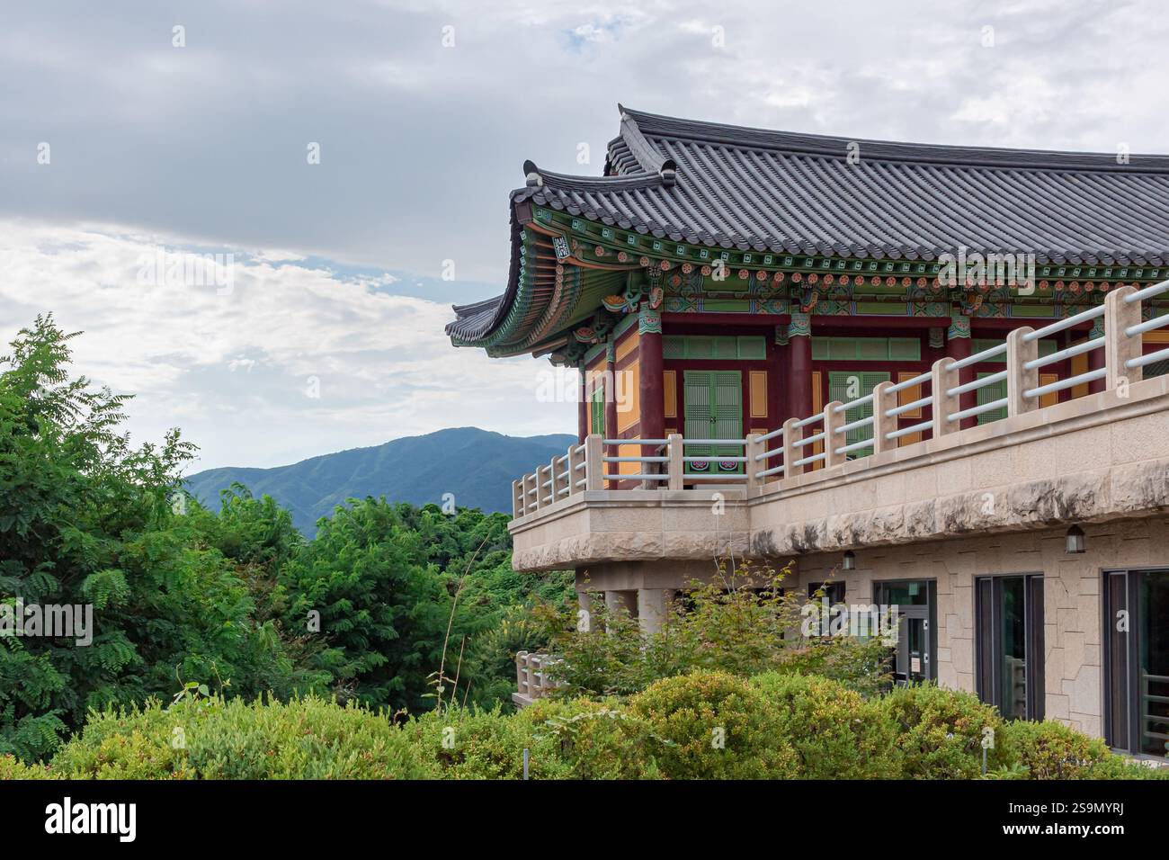 Traditional Korean architecture and lush green forest and mountains at ...