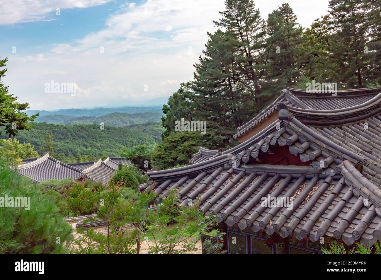 Traditional Korean architecture and lush green forest and mountains at ...