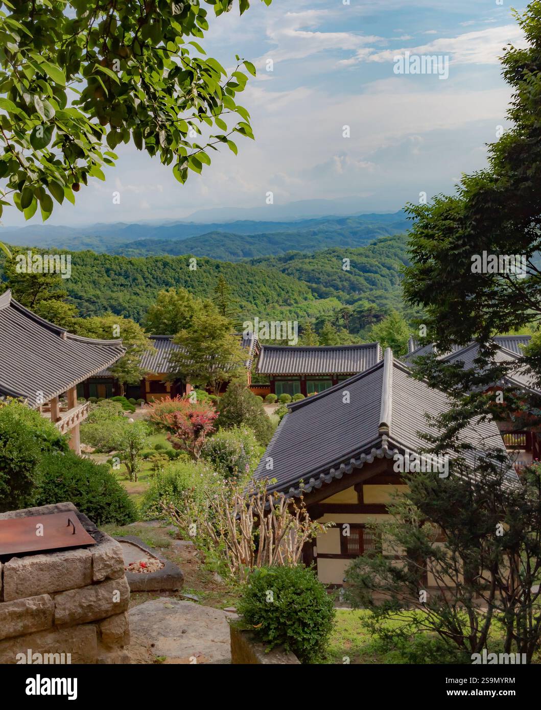 Traditional Korean architecture and lush green forest and mountains at ...
