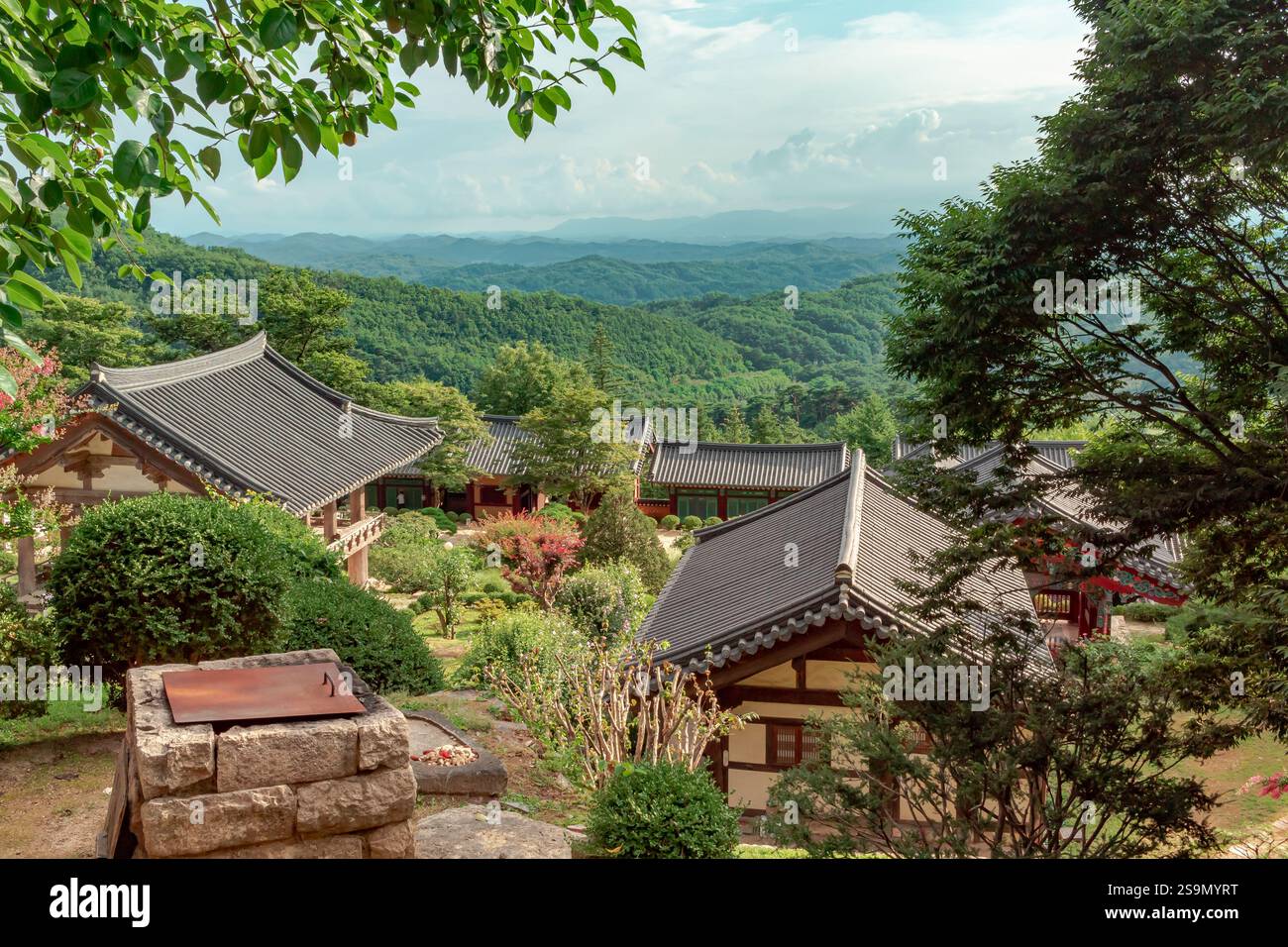 Traditional Korean architecture and lush green forest and mountains at ...