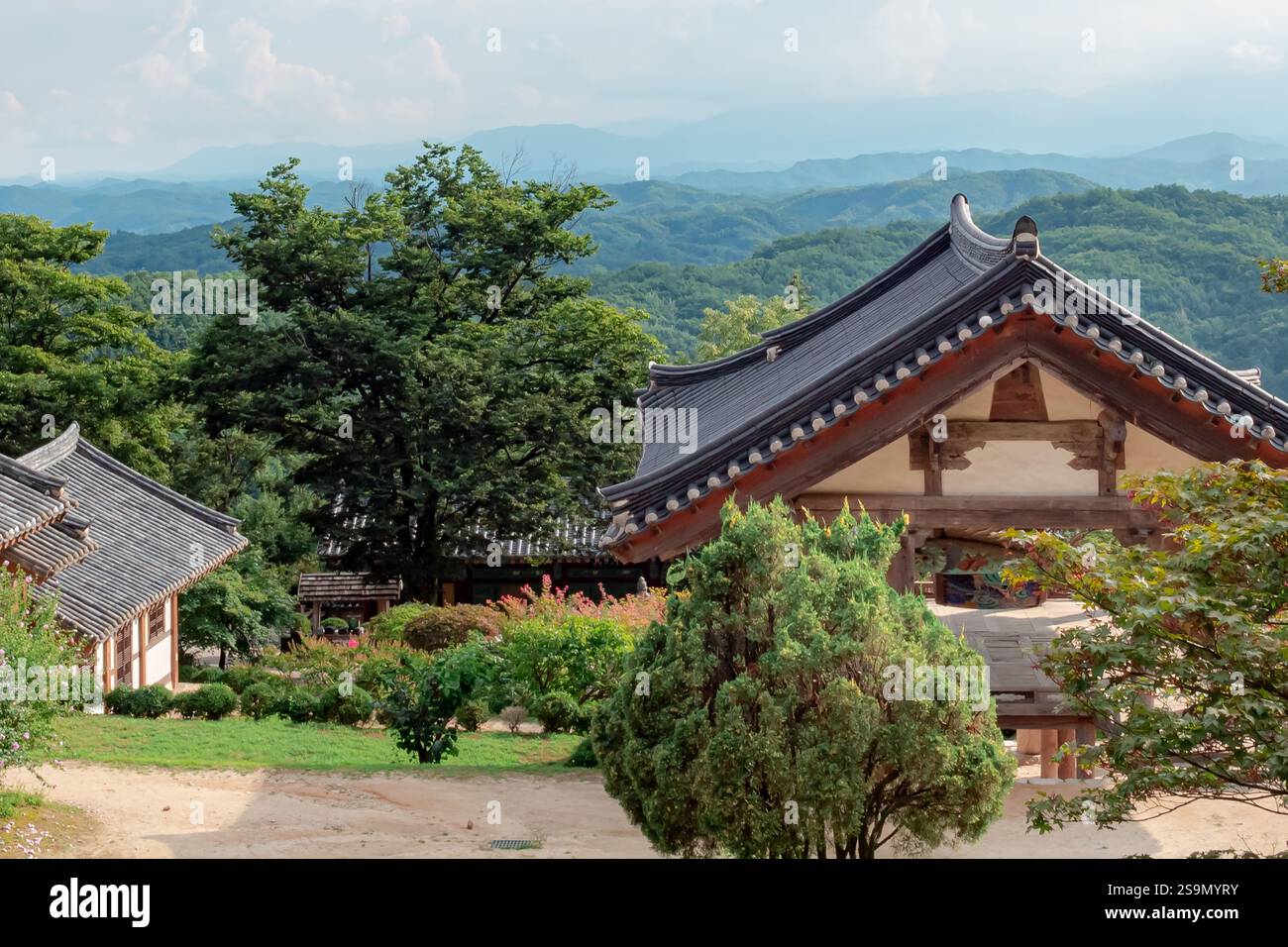 Traditional Korean architecture and lush green forest and mountains at ...