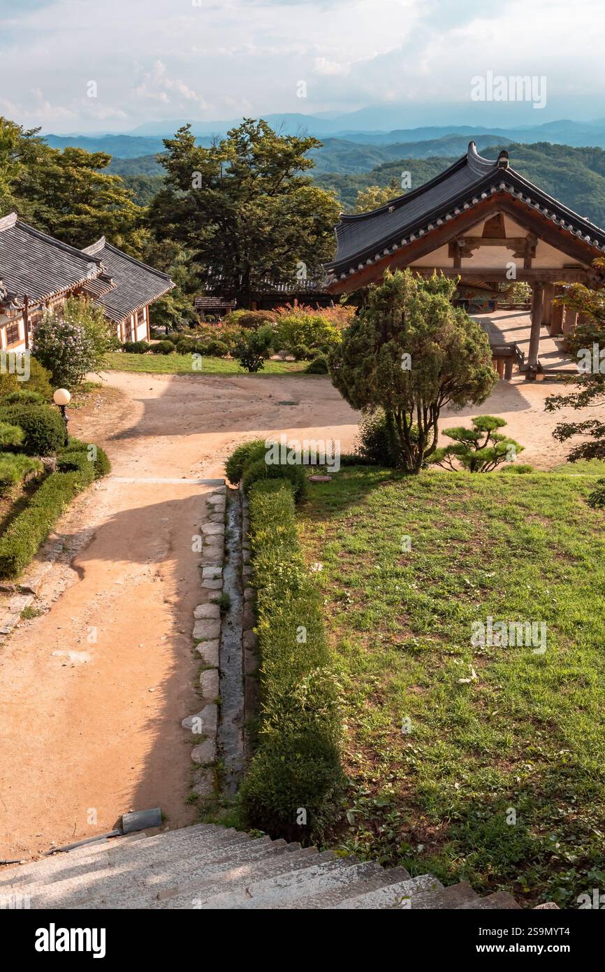 Traditional Korean architecture and lush green forest and mountains at ...