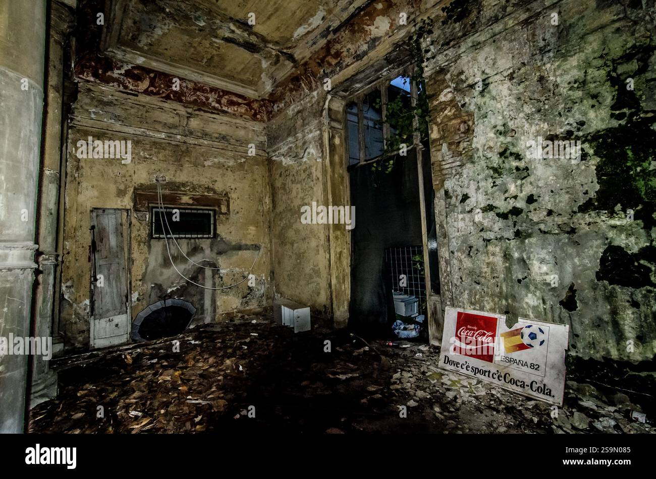 The interior space shows peeling walls and debris scattered on the ...