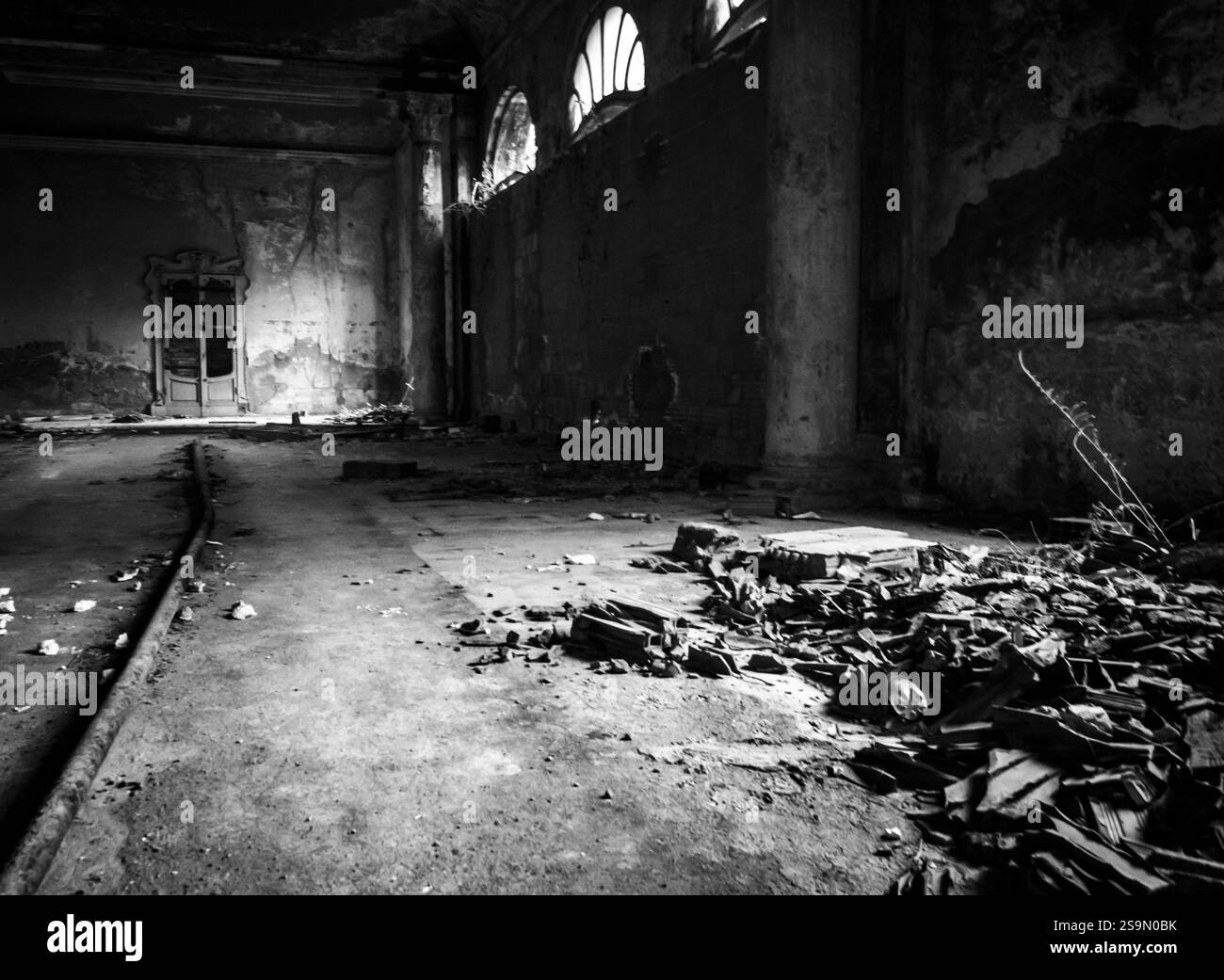 Inside an abandoned structure, neglected walls show signs of decay ...