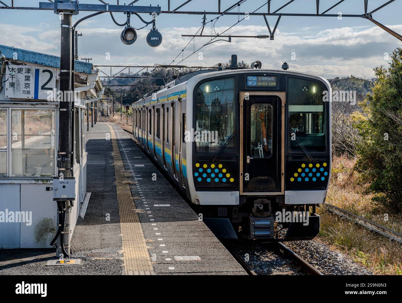 A JR East Uchibo Line E131 Series train arrives at Sanukimachi Station ...