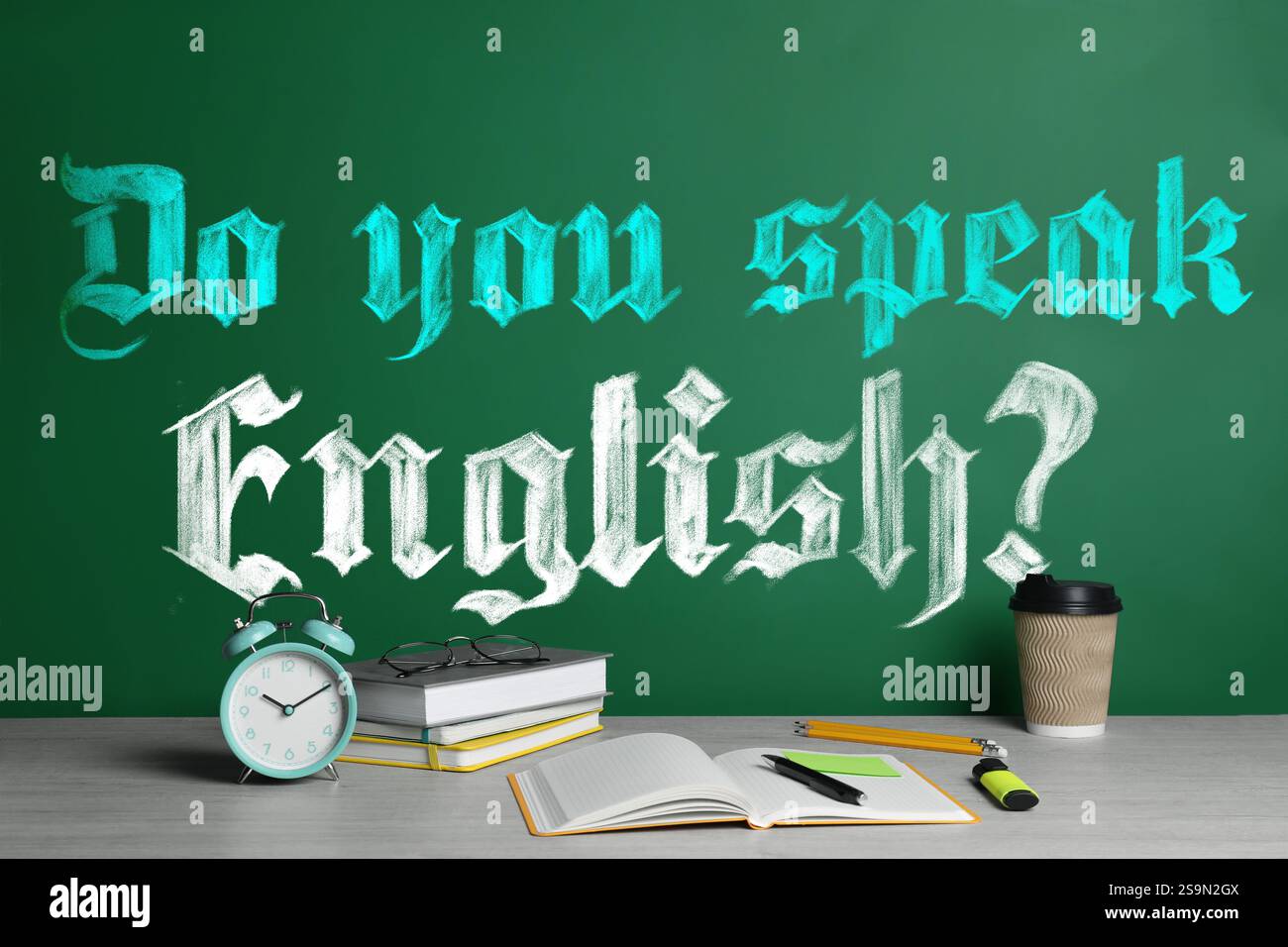 Do You Speak English? text on green chalkboard and stationery on desk ...