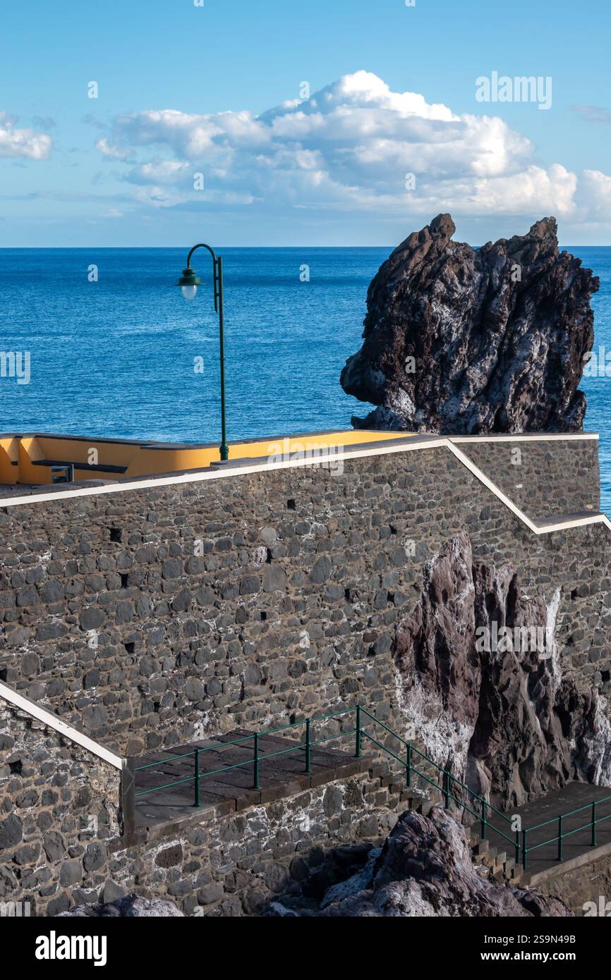 Stone bridge as a pier to the Atlantic ocean. Blue sky with white ...