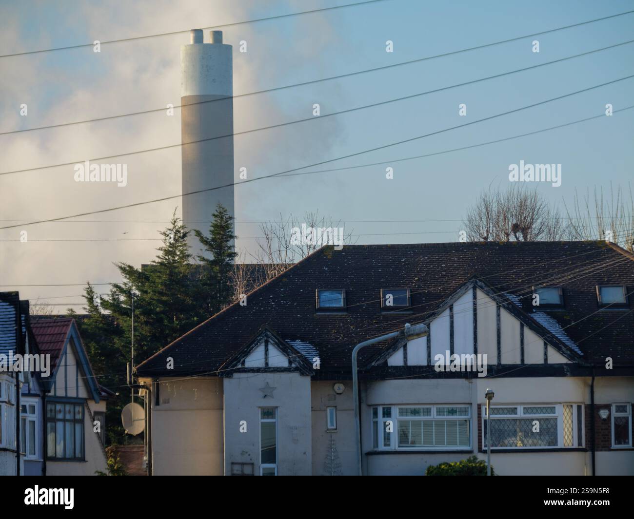 Residential housing in front of Incinerator Chimney at EcoPark a waste ...