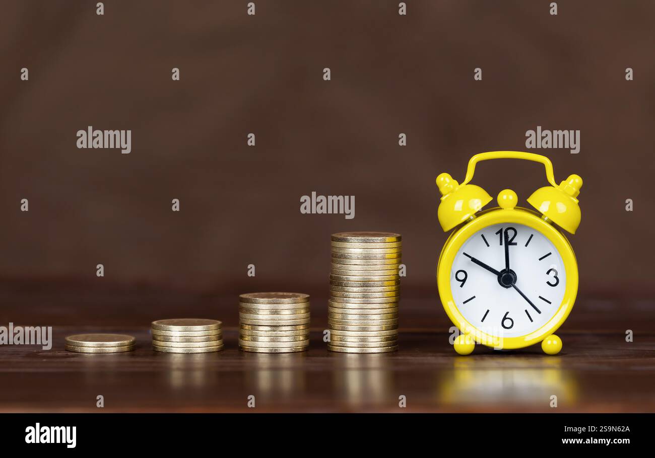 Gold coin stacks and alarm clock. Time is money, savings background ...