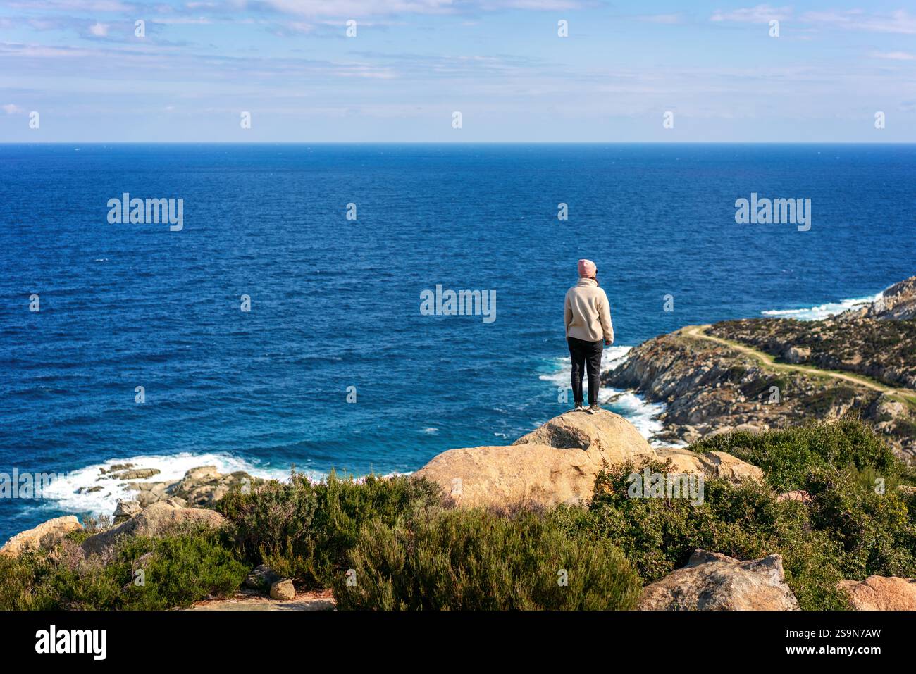 Back view of woman looking at the greek coast cliff landscape Stock ...