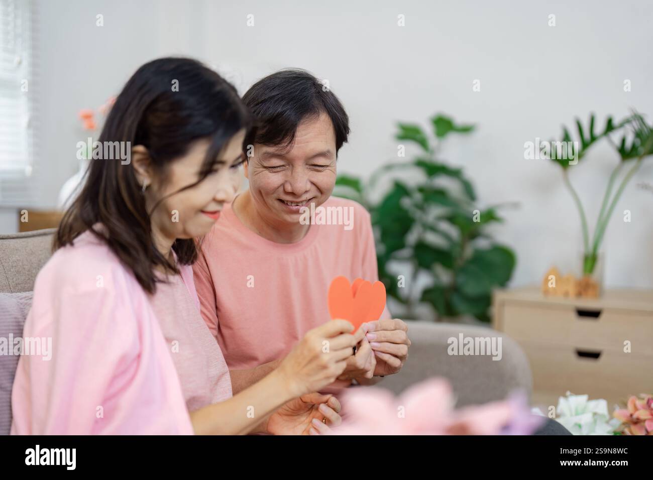 Senior couple exchanging heartfelt messages with love notes on ...