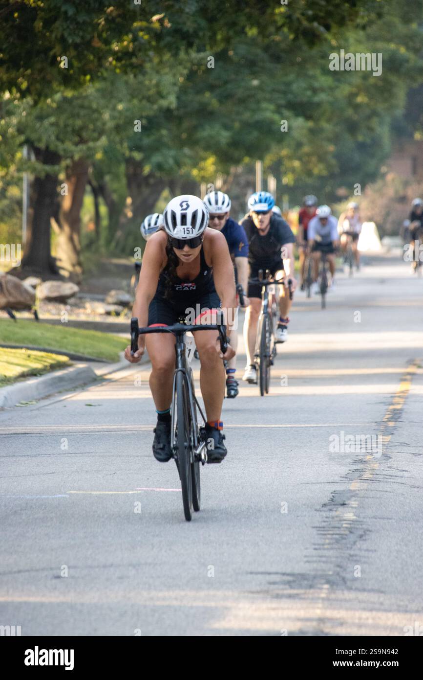 Group of athletes cycling in a line on a road in Apple Sprint Triatlon ...