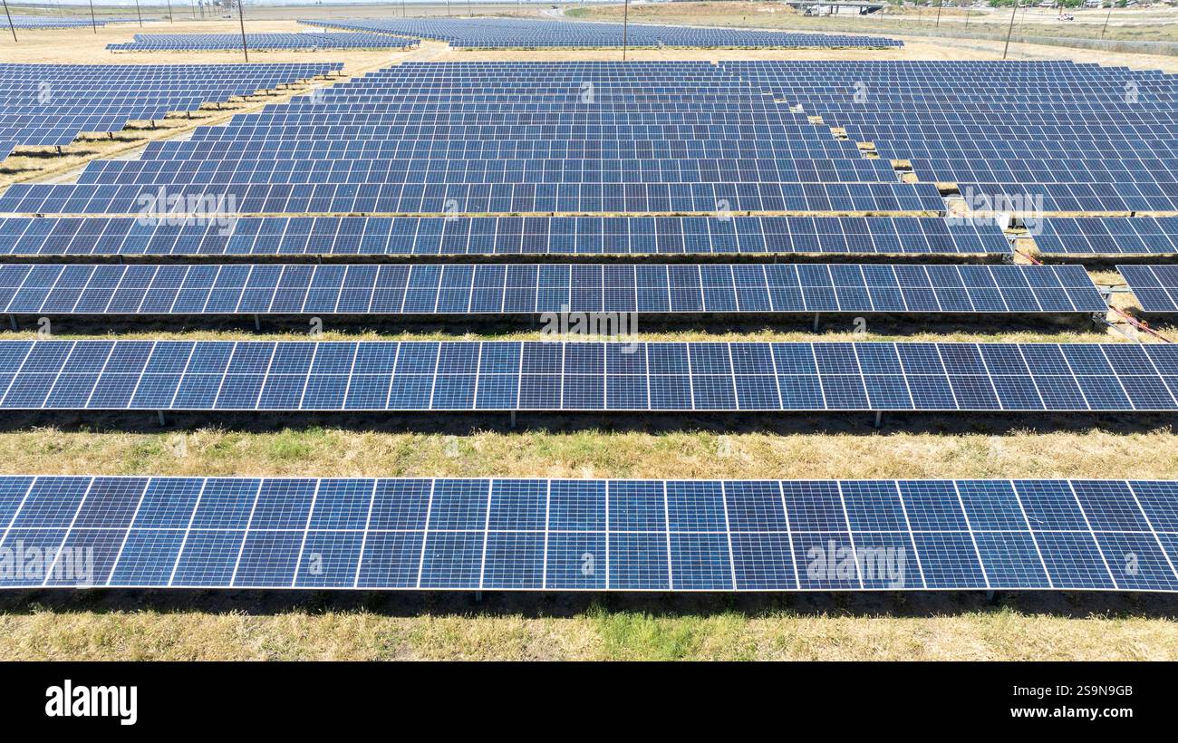 Aerial view of solar array farm on dry grass in Central California ...
