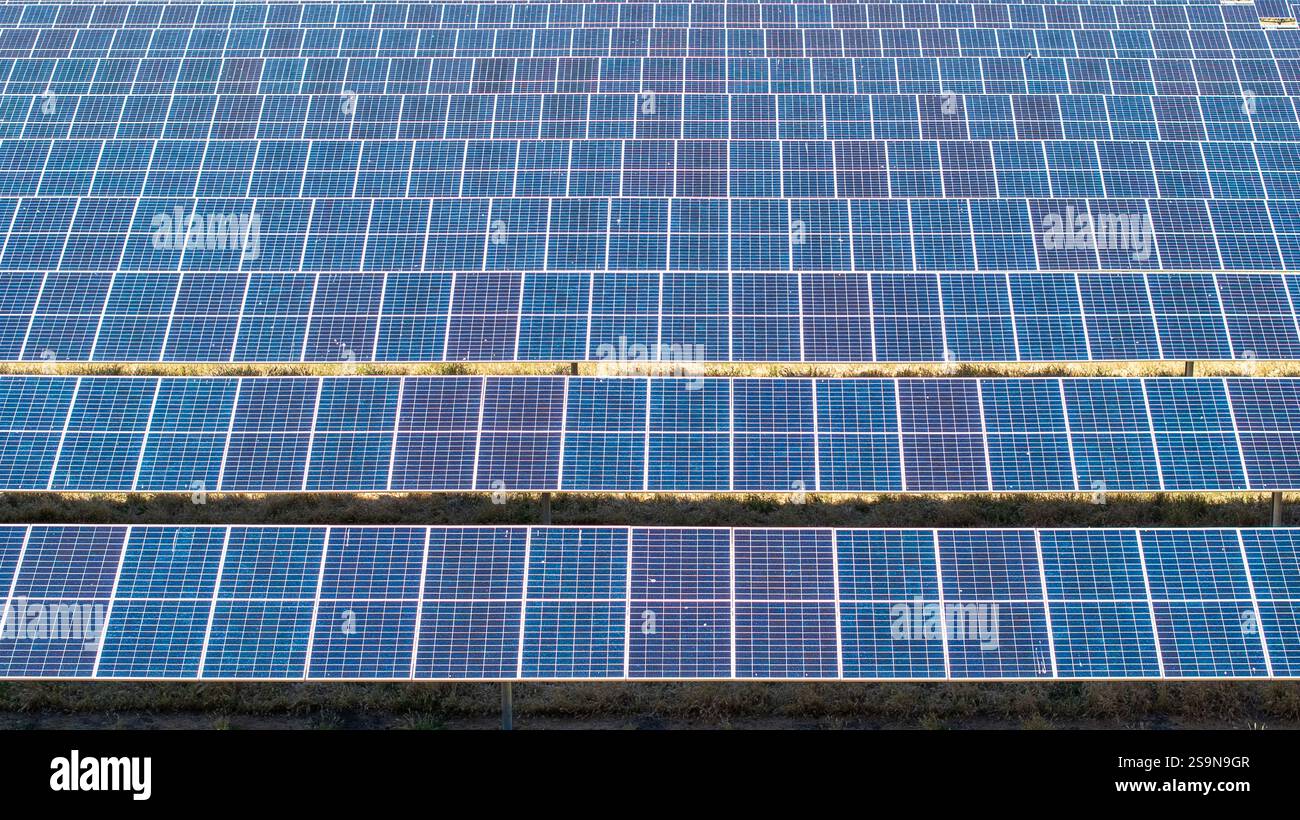 Solar array panels lined up horizontally on a farm Stock Photo - Alamy