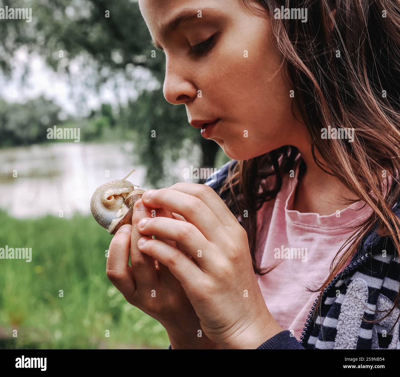 A girl admiring the snail Stock Photo - Alamy