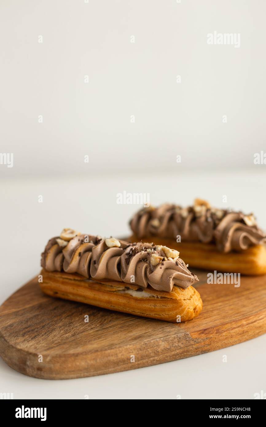 Eclairs hazelnut chocolate cream filling against white background Stock ...
