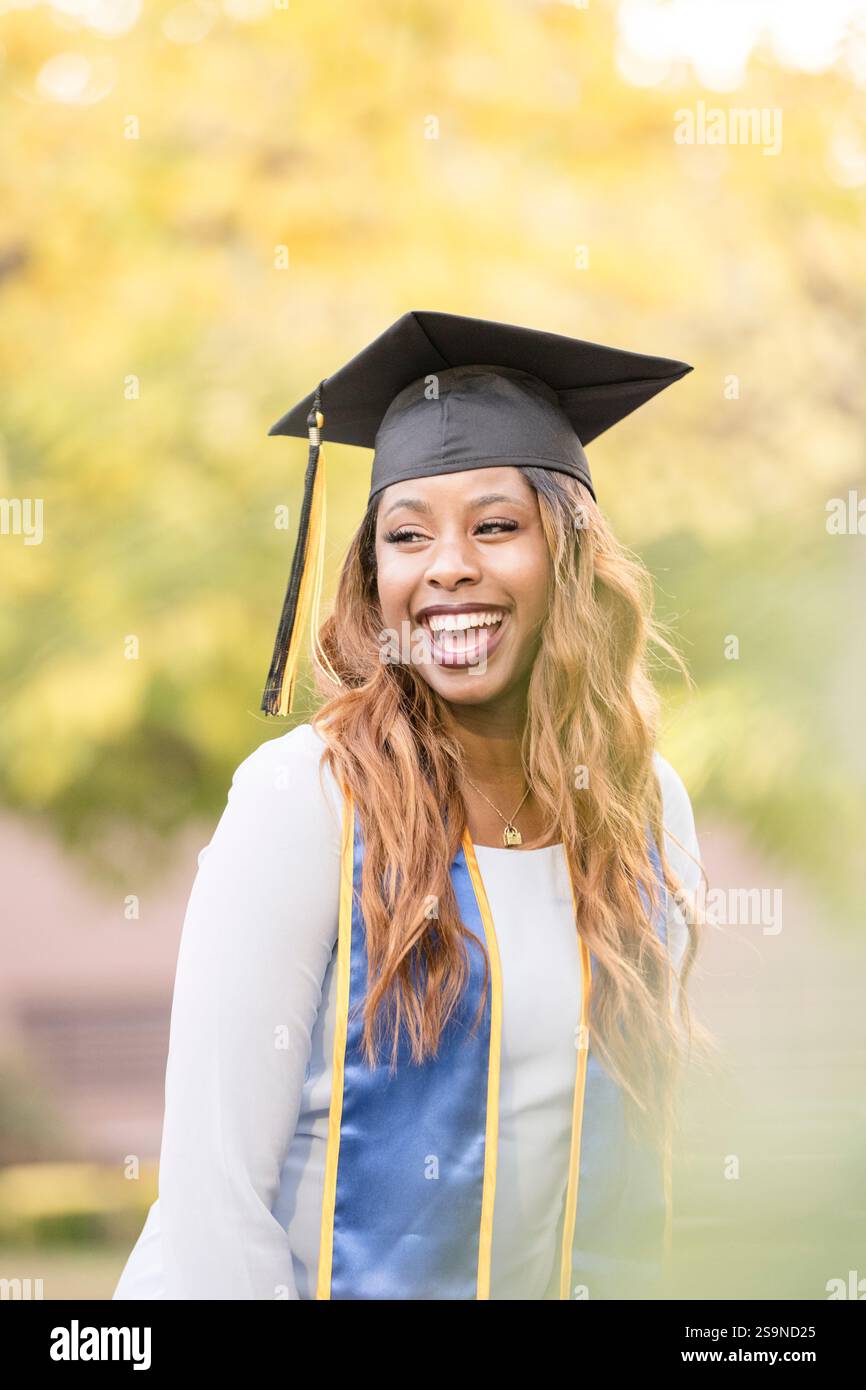 African Americna woman wearing graduation cap and laughing Stock Photo ...