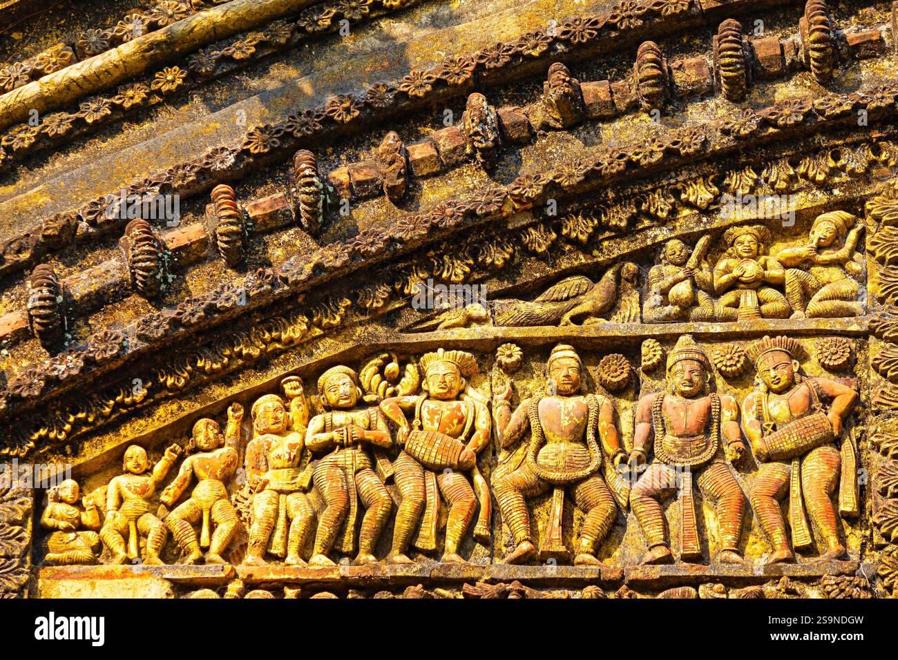 Terracotta carvings of a group of dancers depicted on the entrance arch ...
