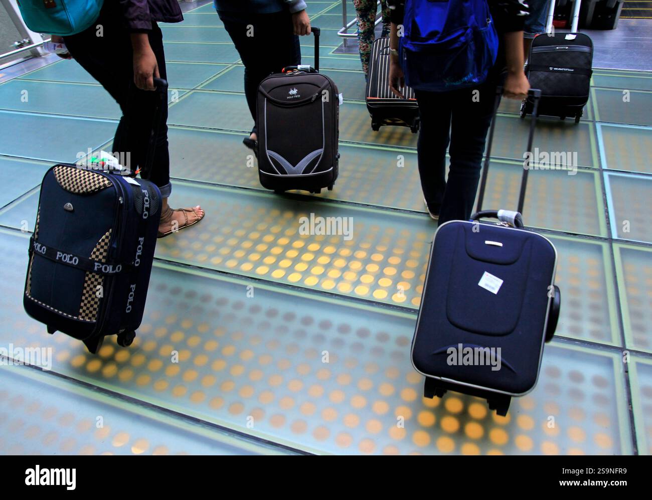 Tourists dragging travel bags at the arrival gate of the airport Stock ...