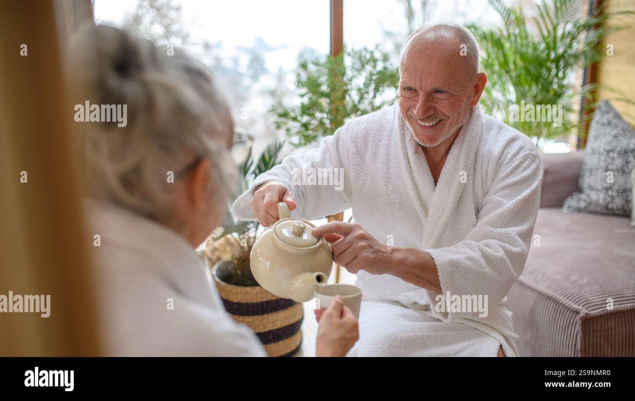 Cup of tea after a spa session. Seniors sitting in a relaxation room ...