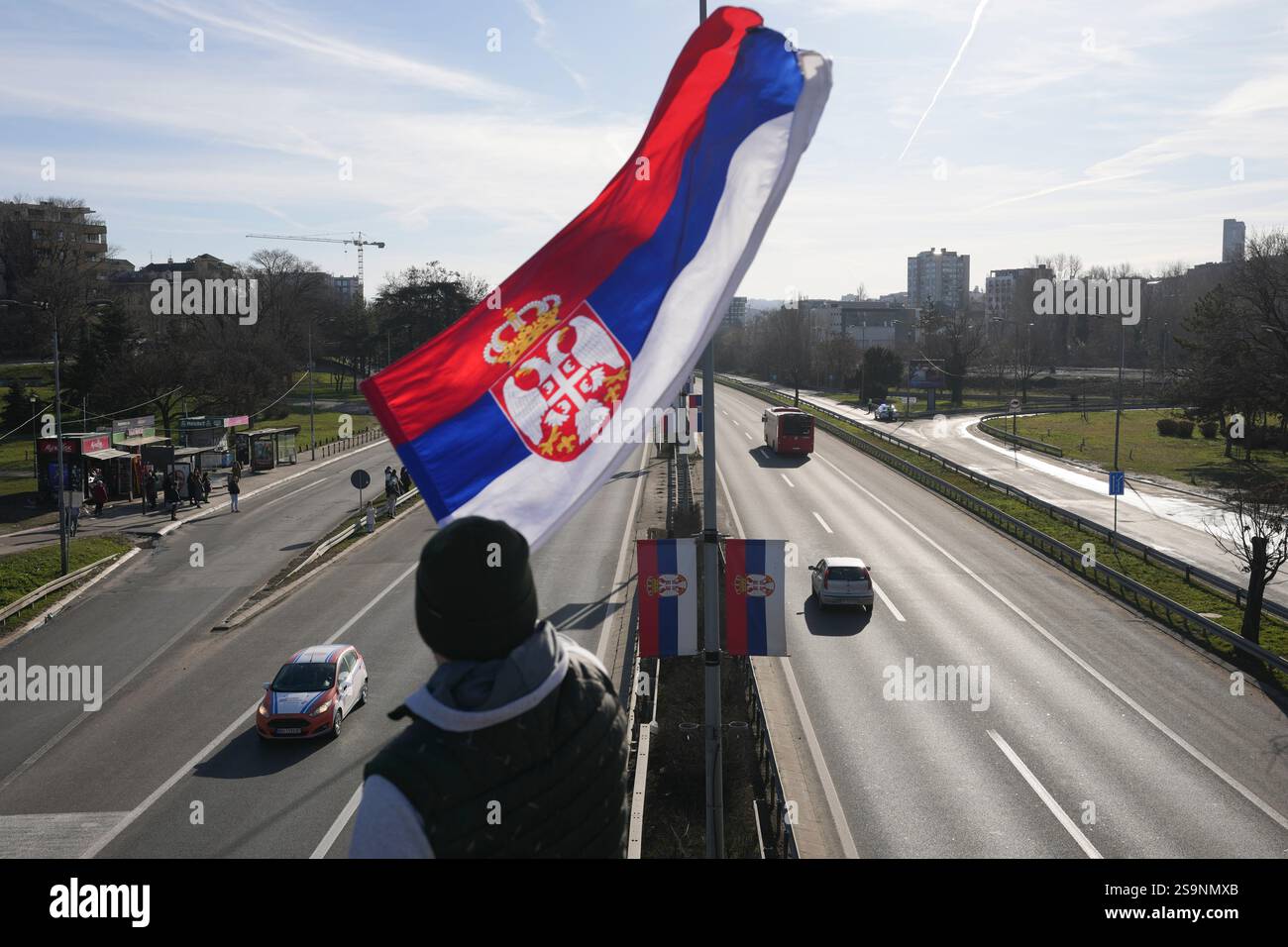 A protester waves a Serbian flag during a student-led 24 hour block on ...