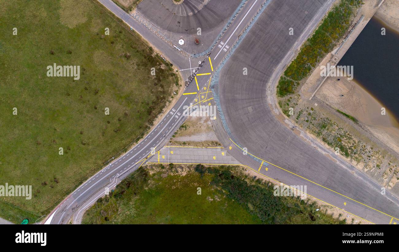 Aerial view of a road intersection with clear yellow and white markings ...