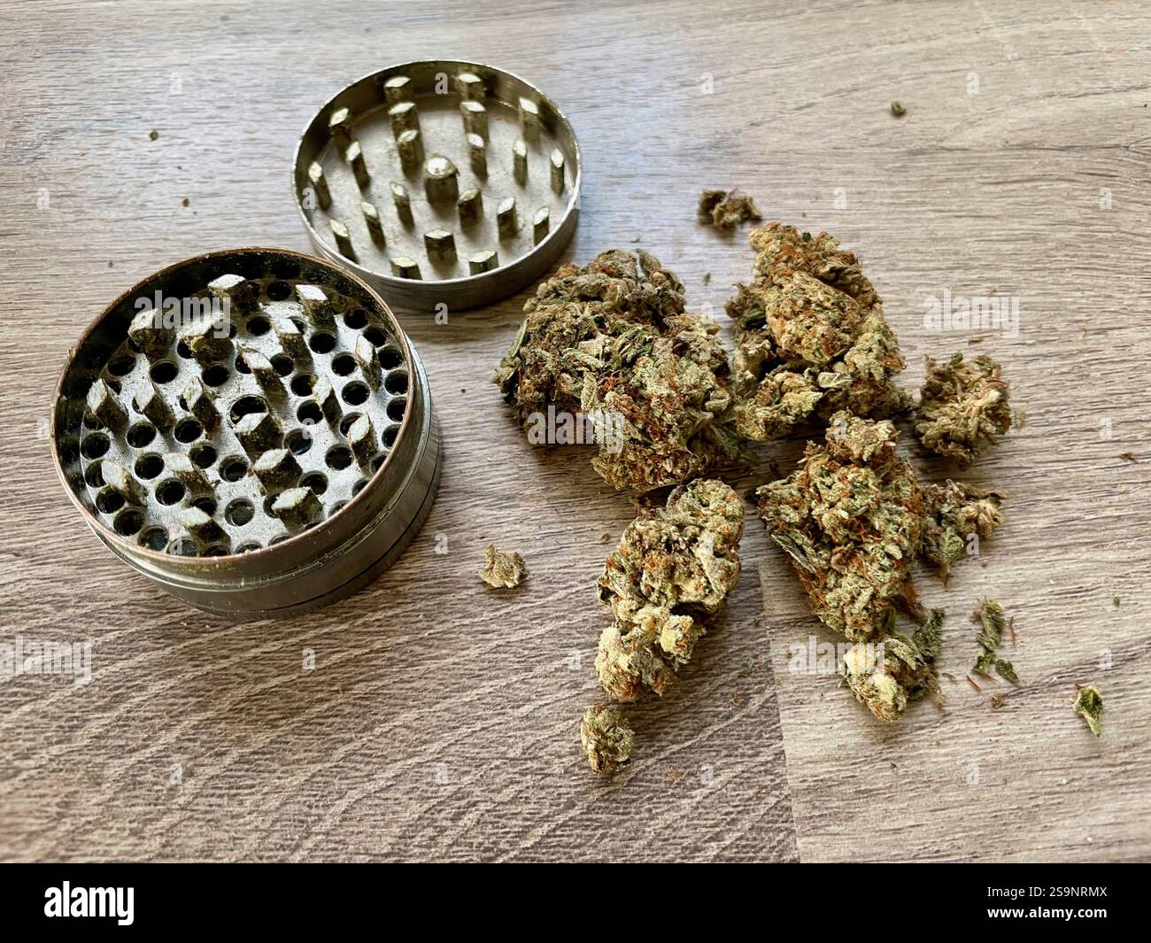 marijuana weed cannabis buds with a grinder on a table Stock Photo - Alamy