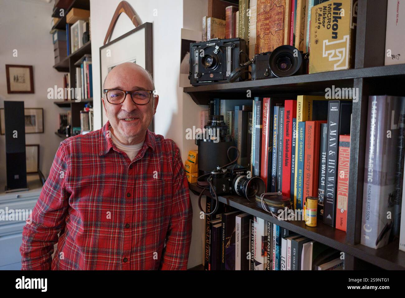 A portrait at the home of the photographer David Levenson surrounded by ...