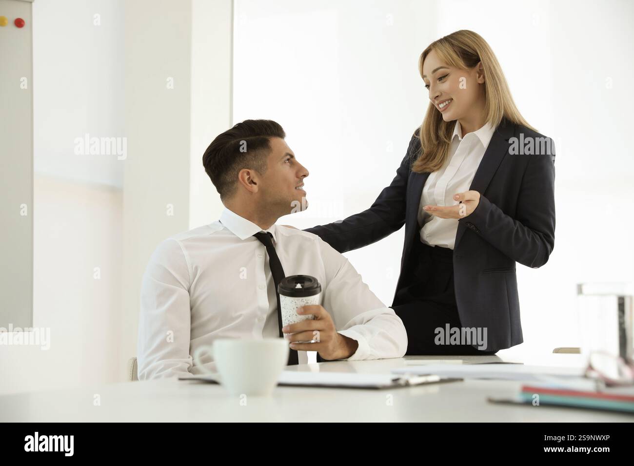 Office employees talking at workplace during break Stock Photo - Alamy