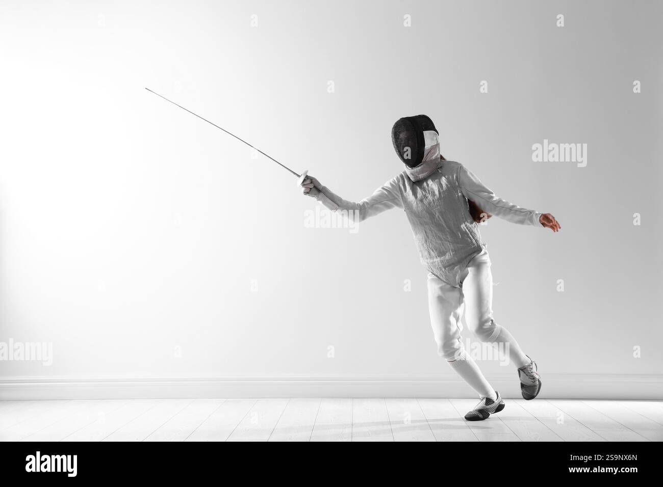 Fencer with epee practicing indoors. Combat sport Stock Photo - Alamy