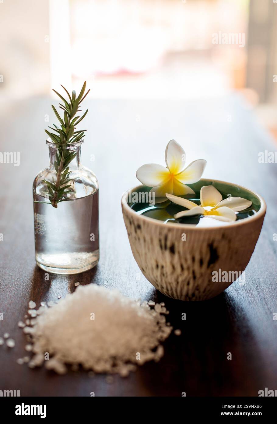 Flower, rosemary and water in spa with bath salts for skincare ...