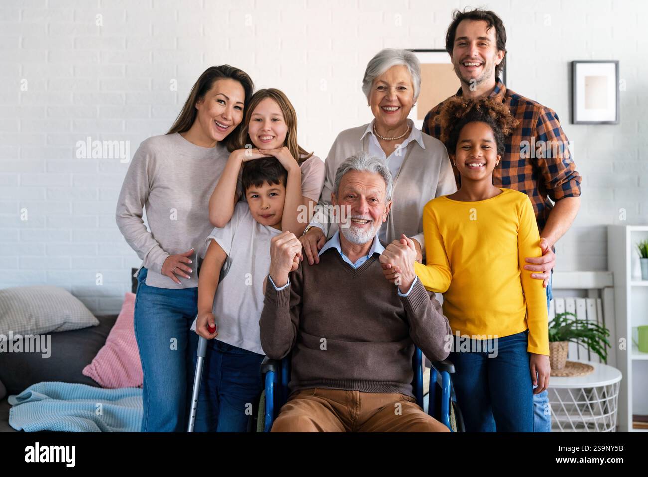 Multi generation, multiethnic family at home together, grandfather with ...