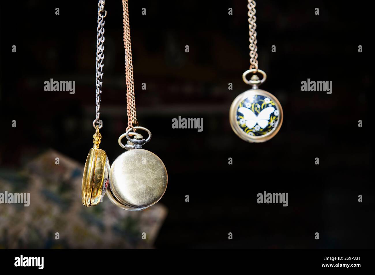 Antique, gold, pocket watches and chains hanging in a vintage store in ...