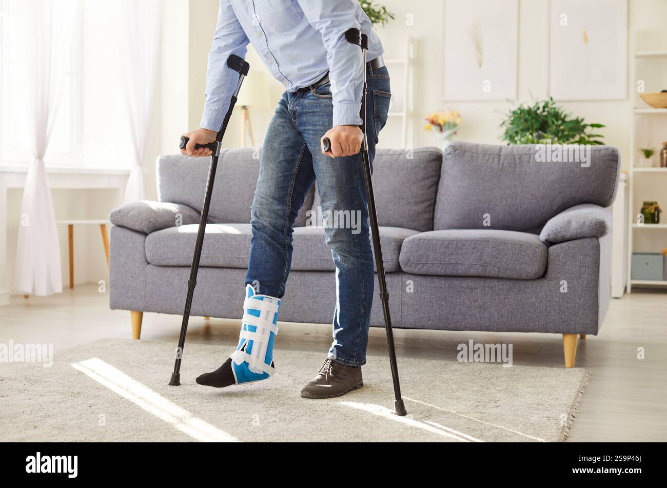 Man wearing sling on broken injured leg, rehabilitation after hurt ...