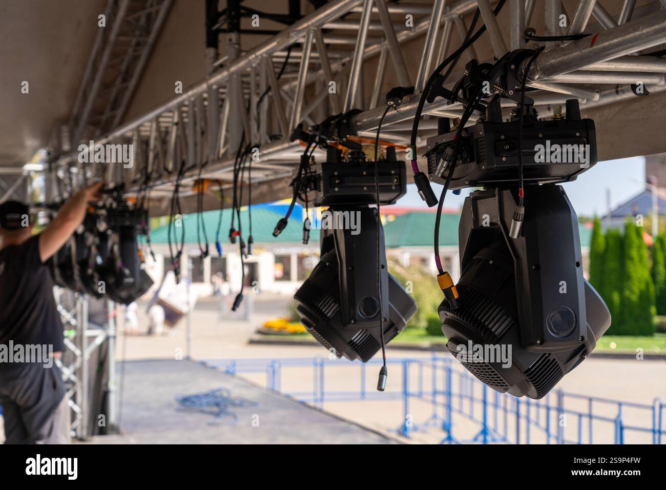 Installation of lighting equipment on a mobile concert stage. A worker ...