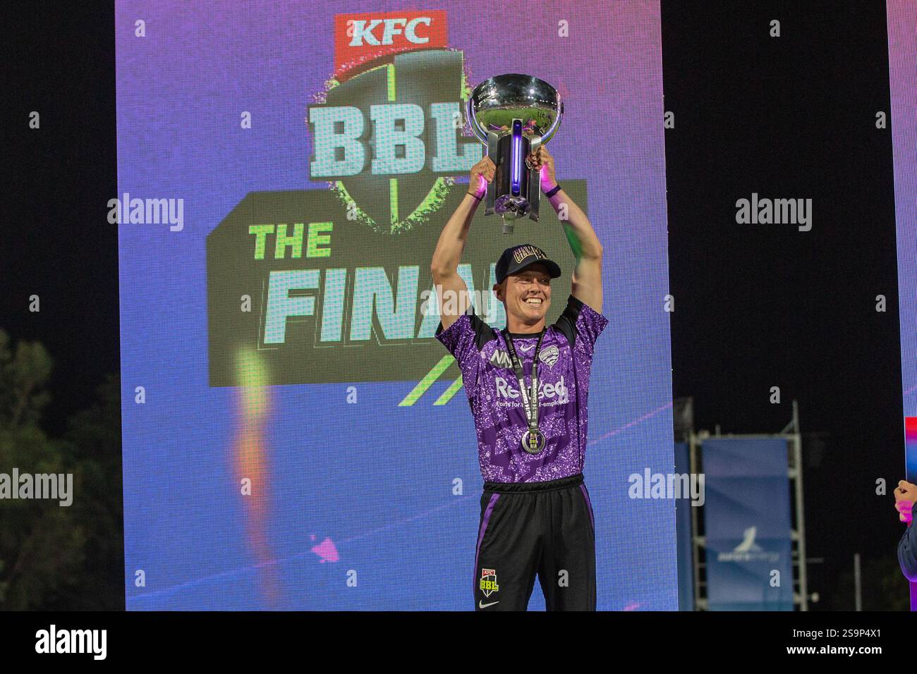 Hobart Hurricanes captain Nathan Ellis is presented with the BBL trophy ...