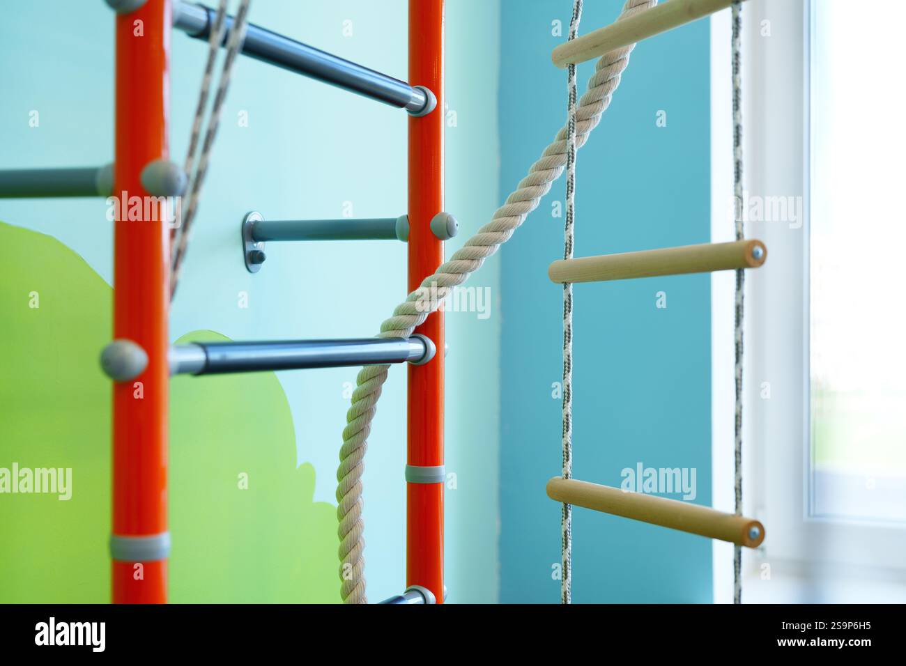 Climbing structure with ropes and bars in a colorful indoor play area ...