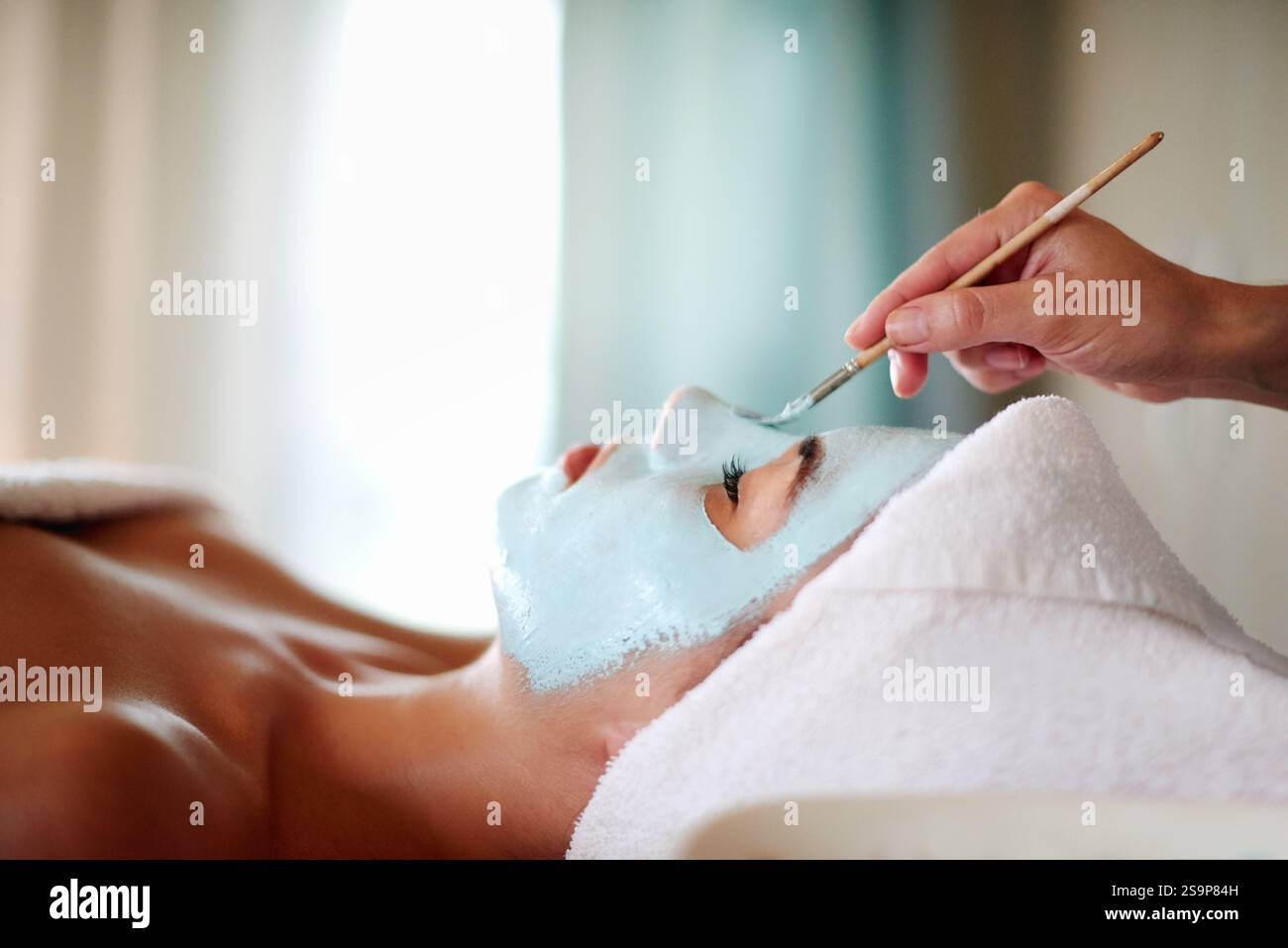 Beauty, hands and client with mask application for facial treatment ...